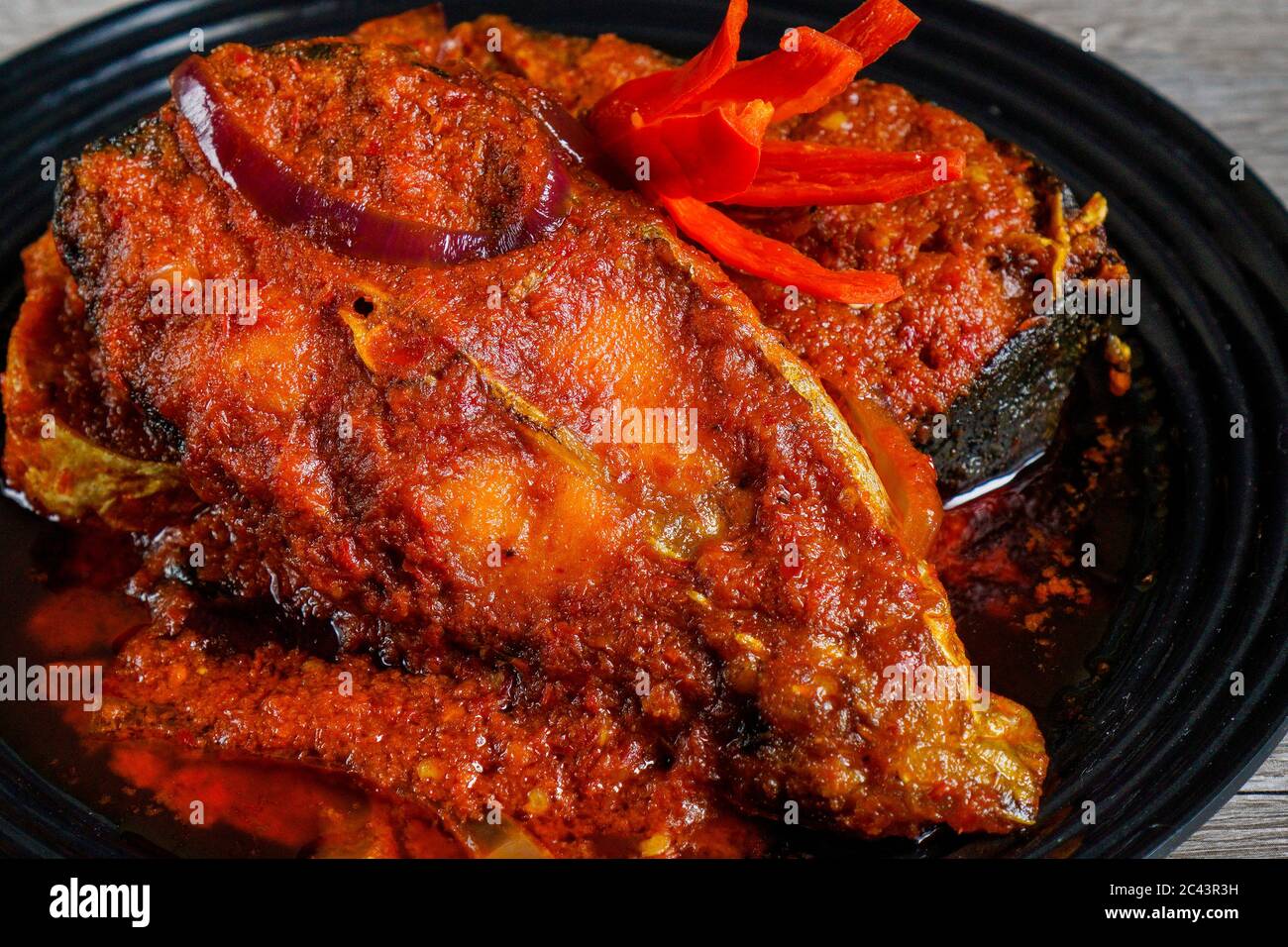 Fried silver catfish cooked with spicy sambal red chilli and onion with ...