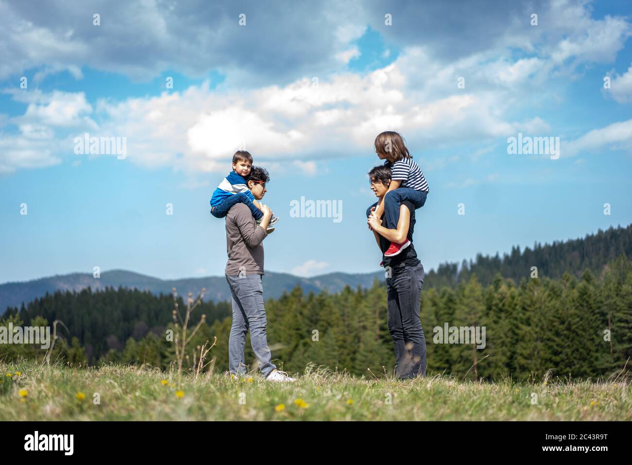 Big brothers piggyback holding little ones Stock Photo - Alamy