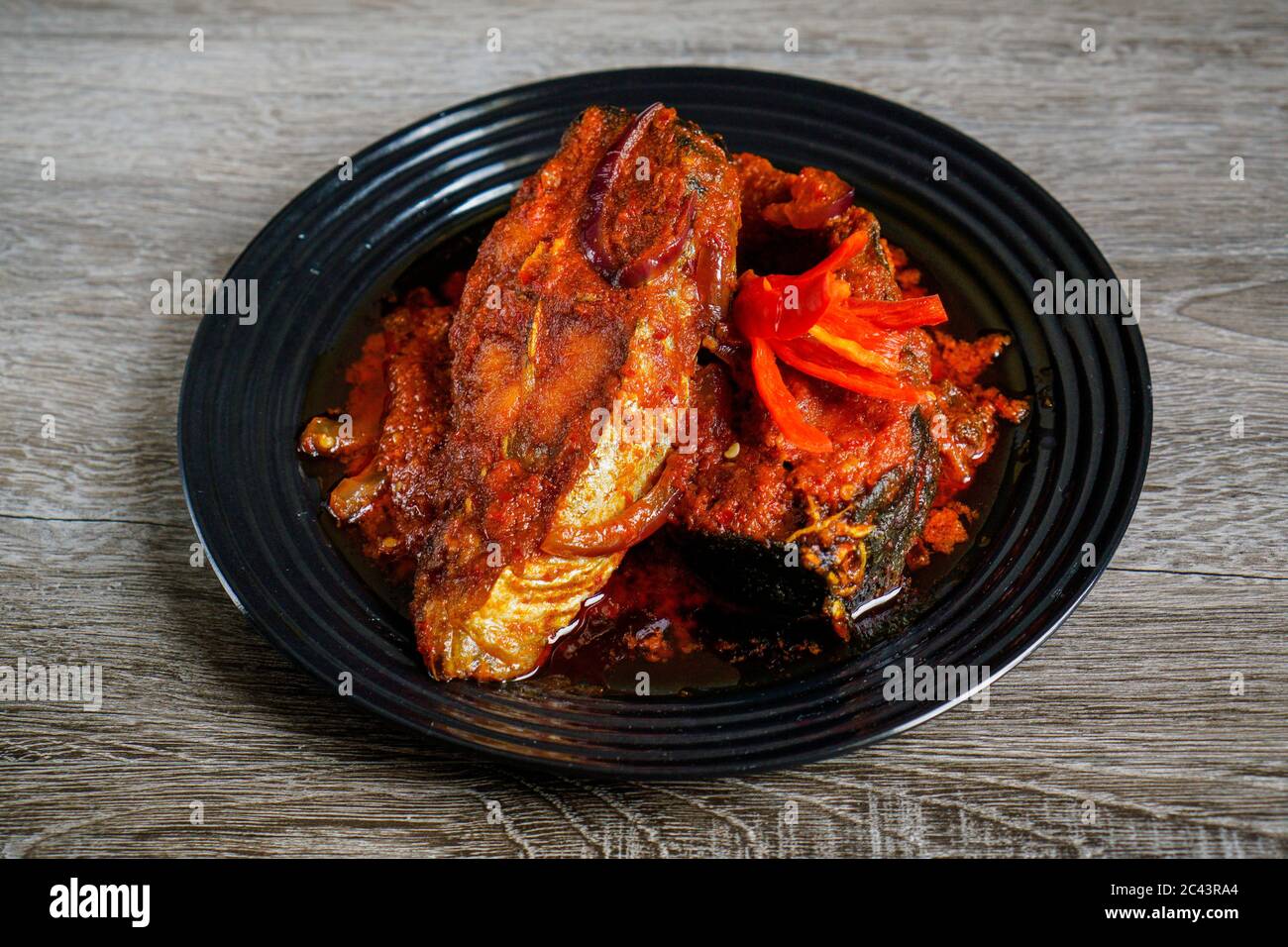 Fried silver catfish cooked with spicy sambal red chilli and onion with ...