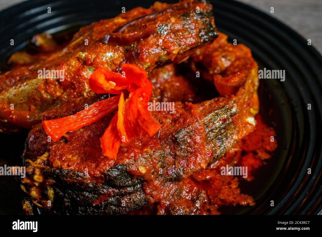 Fried silver catfish cooked with spicy sambal red chilli and onion with ...