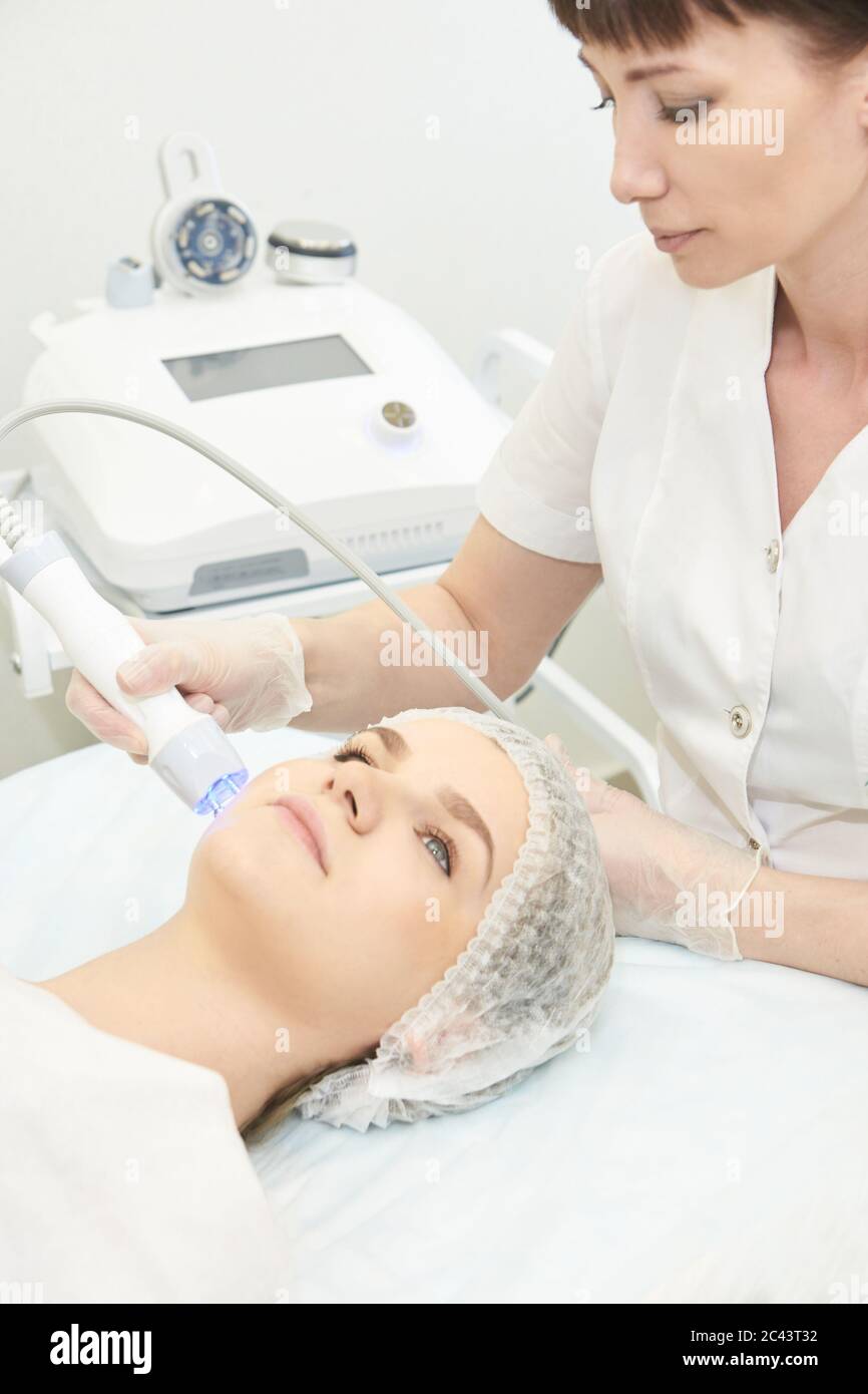 Dermatology treatment in cosmetology clinic. Woman and doctor. Skin ...