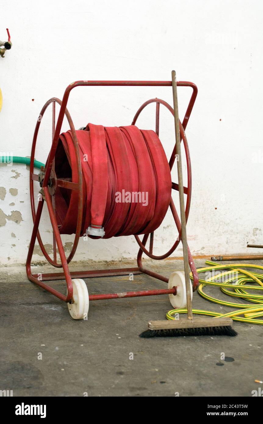 Fire hose and broom Stock Photo - Alamy