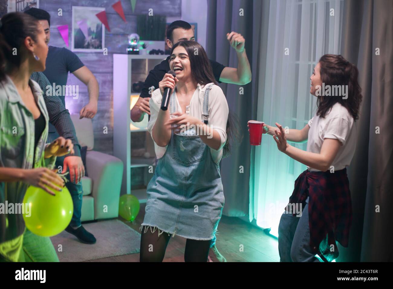 Group of friends singing together at the party. Happy group of people ...