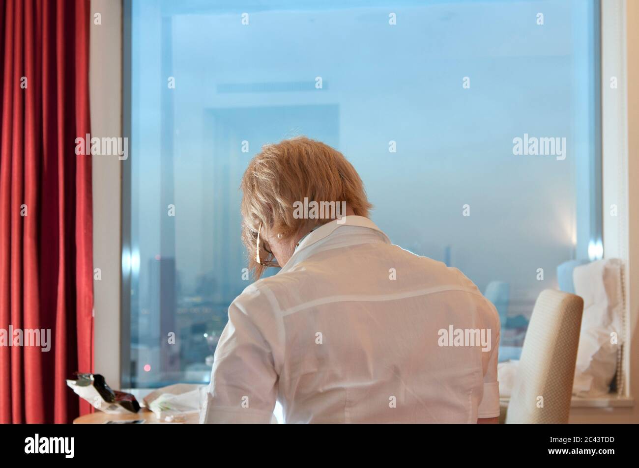 Woman sitting by the window at dusk, Tokyo, Japan Stock Photo - Alamy