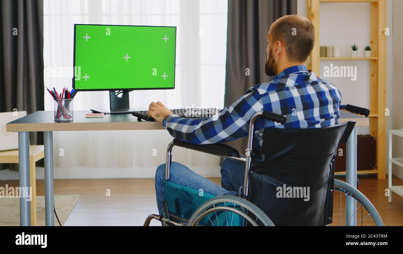 Disabled man using computer typing hi-res stock photography and images ...