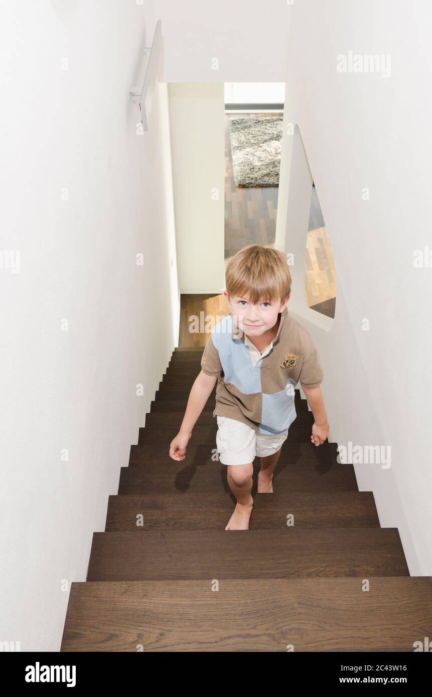 Boy goes up a flight of stairs Stock Photo - Alamy