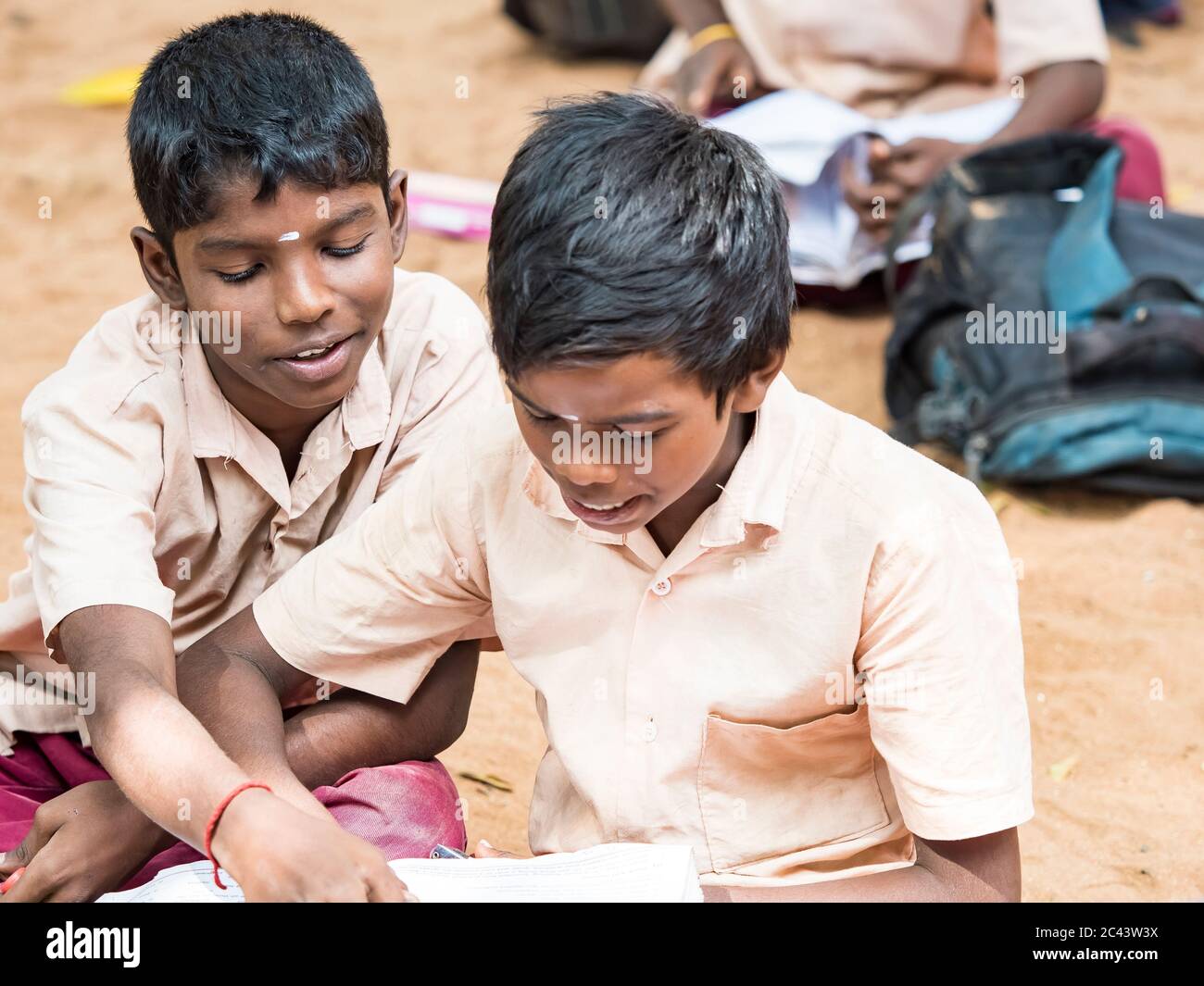 Boy school uniform sitting on floor hi-res stock photography and images ...