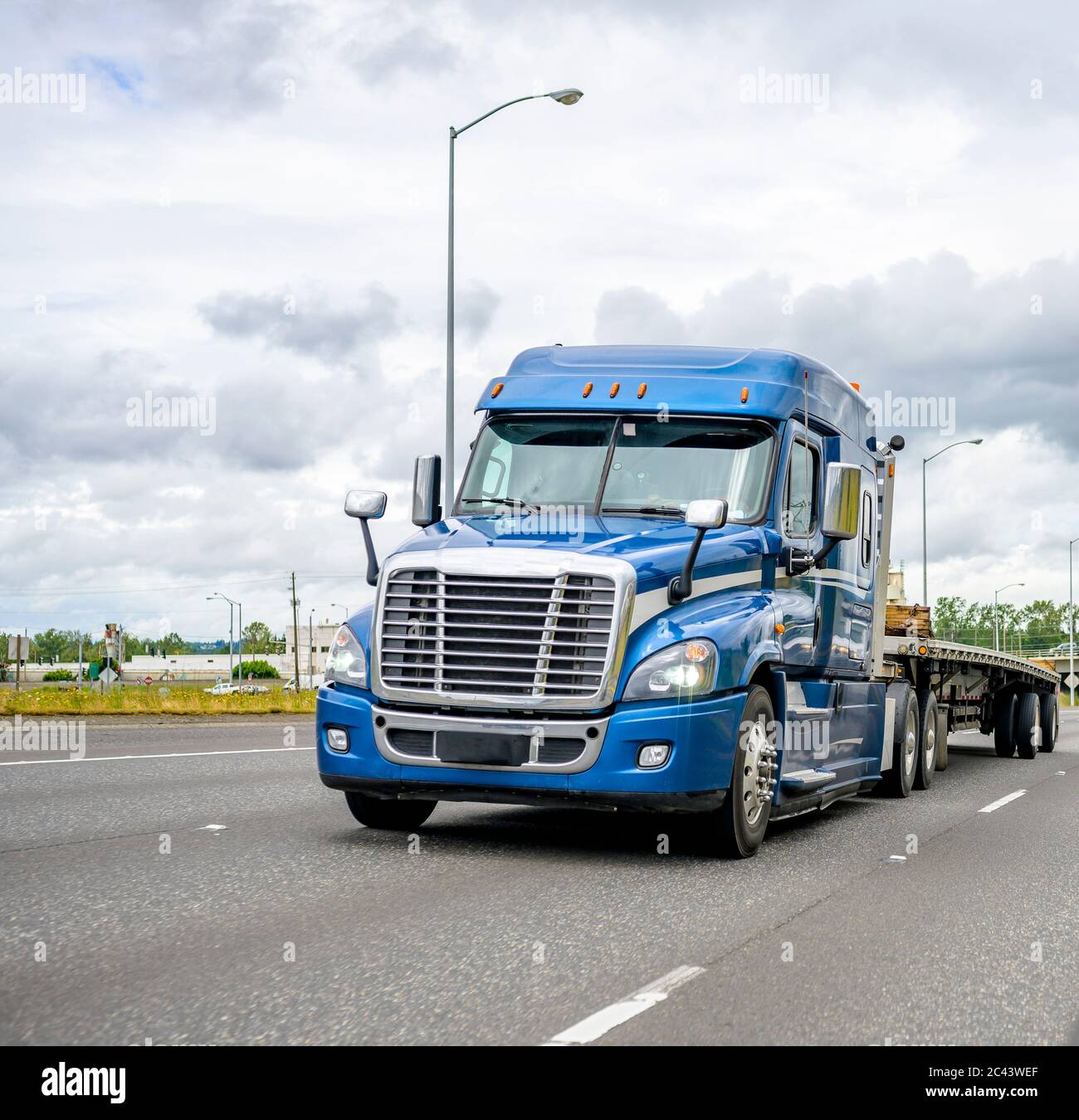 Industrial professional long haul big rig blue diesel semi trucks with ...