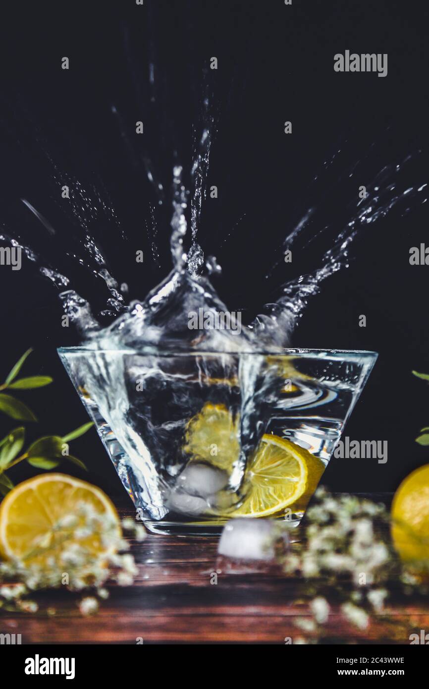 Water splash in a bowl on black background Stock Photo - Alamy