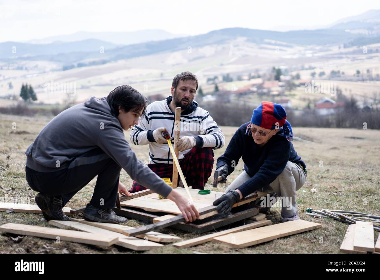 Three generation family working together on project using tools Stock ...