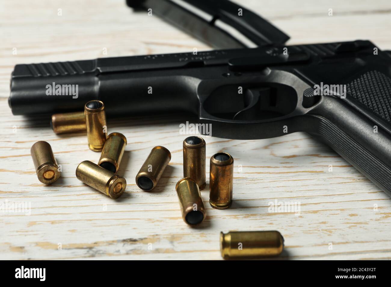 Pistol, bullets and magazine on wooden background Stock Photo - Alamy