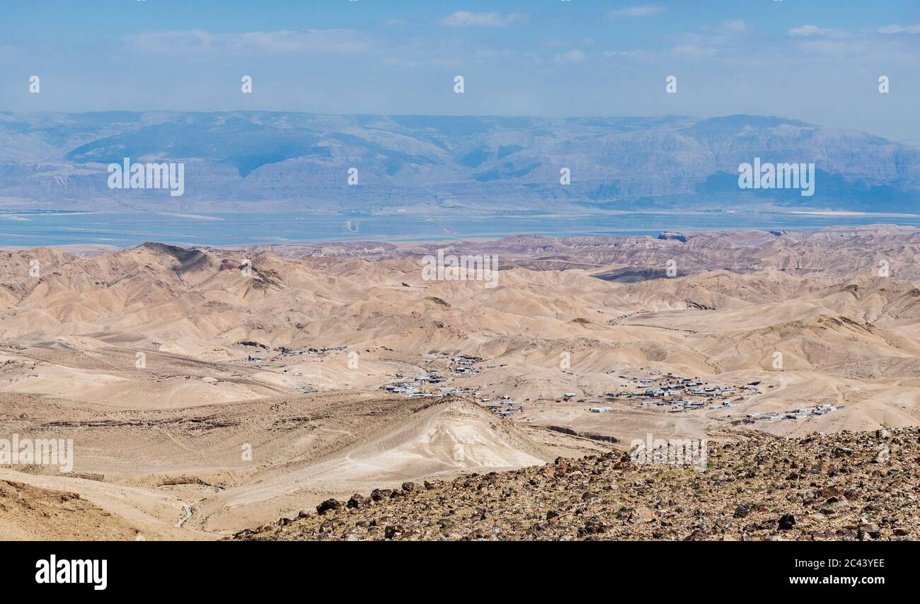 a group of bedouin villages can be seen in the hills between Arad in ...