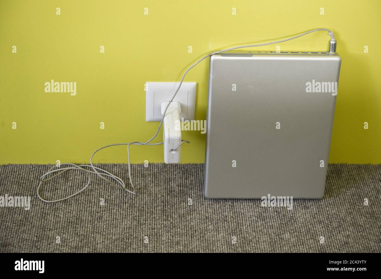 Laptop on an electrical outlet Stock Photo - Alamy