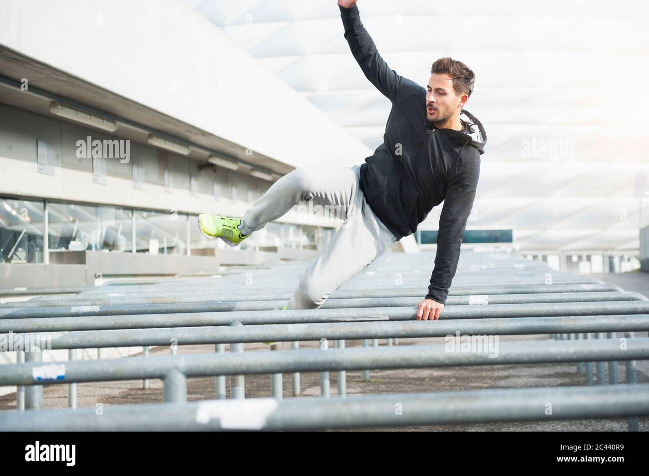 Young man jumping over railing hi-res stock photography and images - Alamy