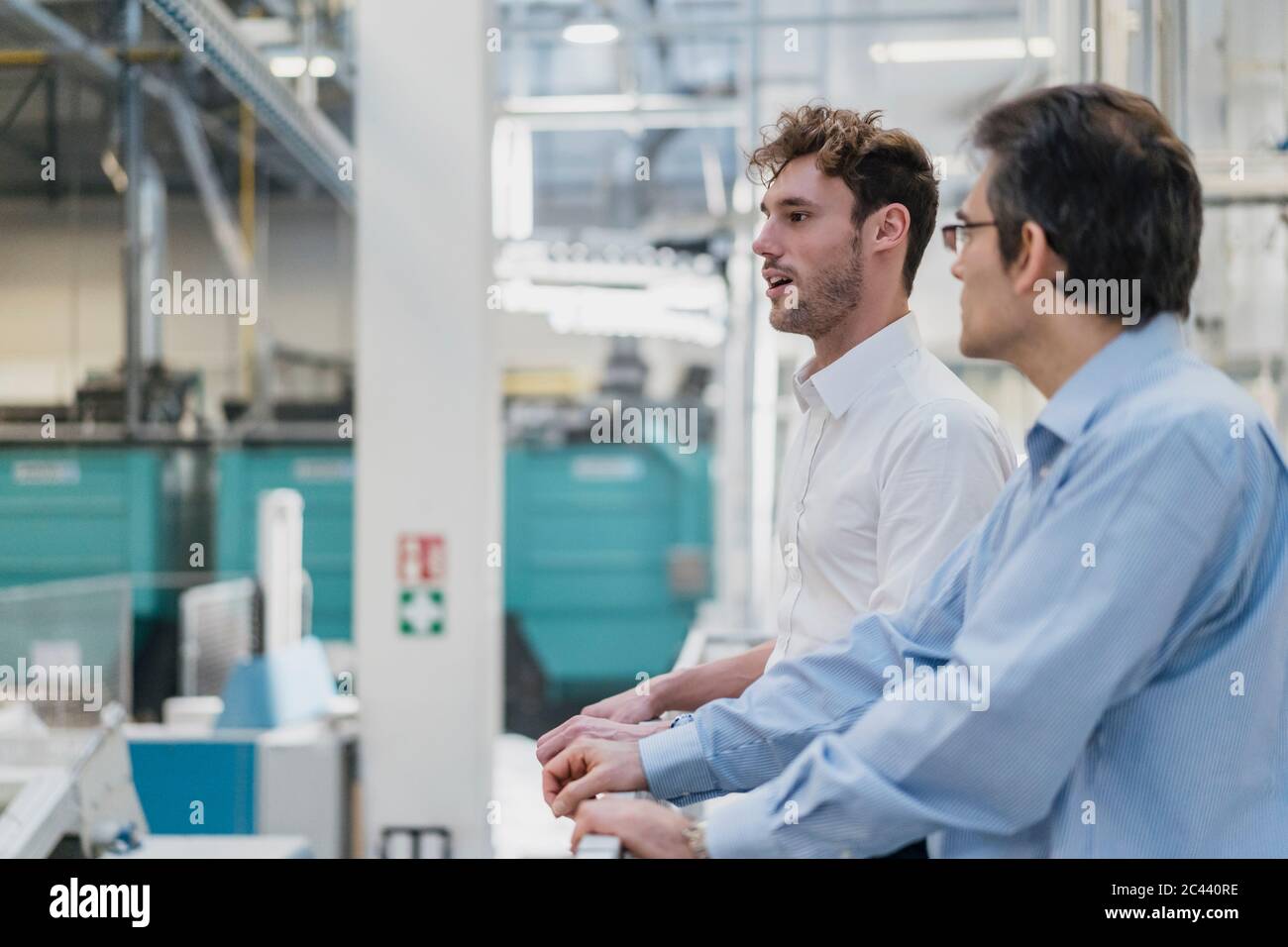 Two businessmen having a meeting in a factory Stock Photo - Alamy