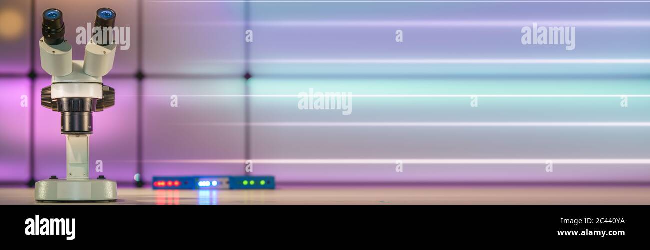 Banner with a microscope on a table in a science lab Stock Photo - Alamy