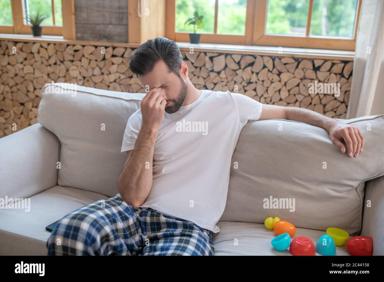 Young happy father sitting on the sofa feeling exhausted Stock Photo ...