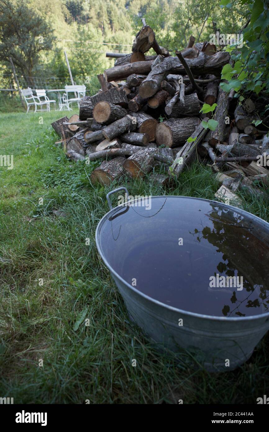 Trough with water and firewood in a meadow Stock Photo - Alamy