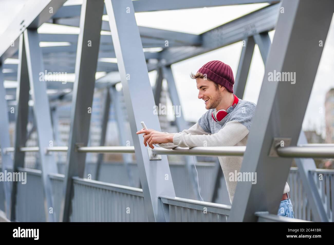 Young man headphones standing bridge hi-res stock photography and ...