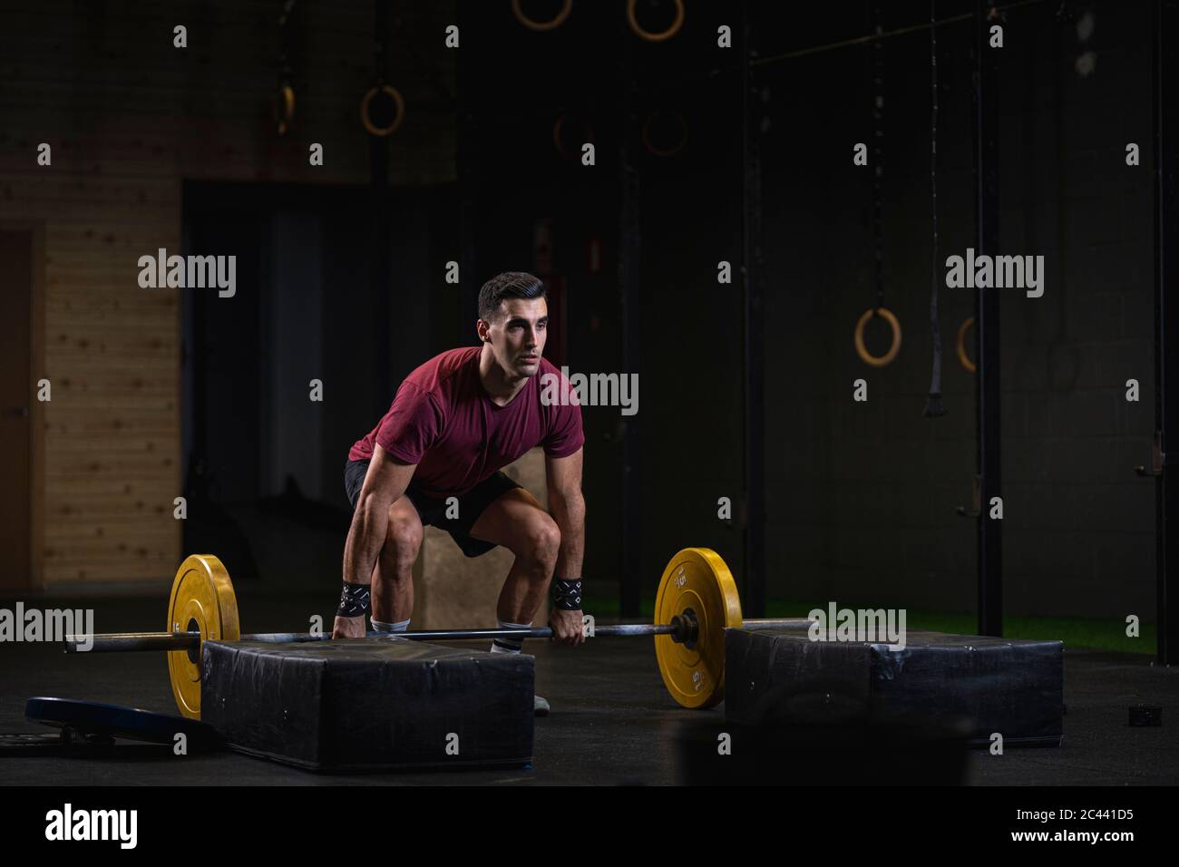 Man doing overhead squat exercise at gym Stock Photo - Alamy