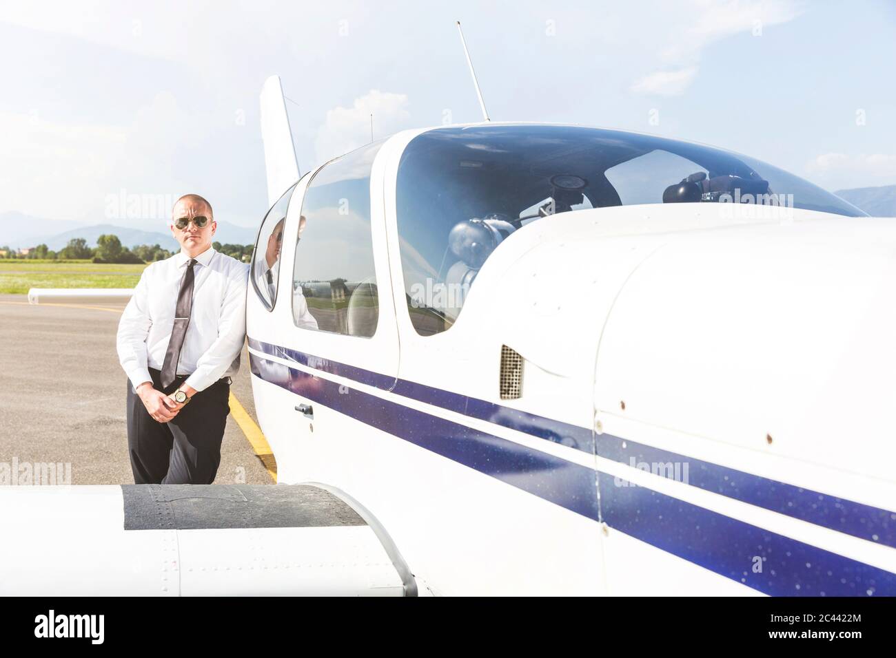 Pilot standing by his sports plane Stock Photo - Alamy