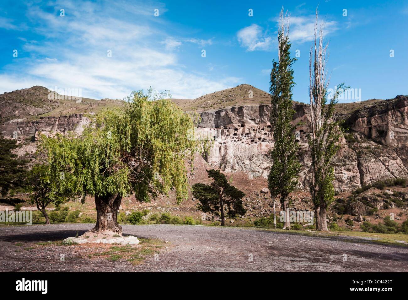 Georgia, Samtskhe-Javakheti, Trees in front of Vardzia cave monastery ...