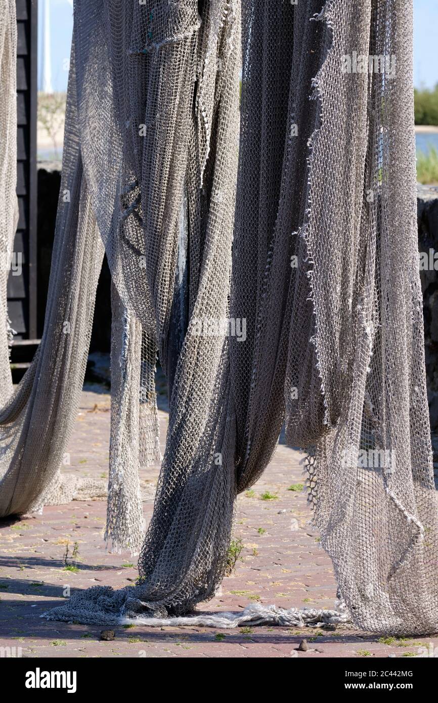 Fishing nets hang to dry in the sun, still lifes and objects. Fishermen ...