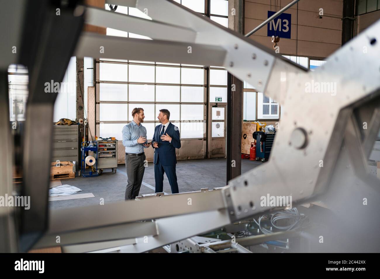 Two businessmen having a meeting in a factory Stock Photo - Alamy