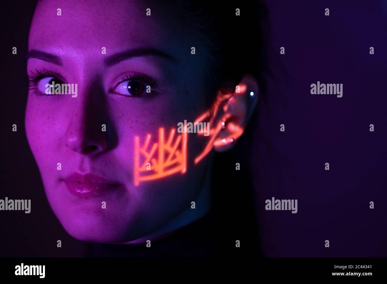 Headshot of woman with light pattern on her cheek Stock Photo - Alamy