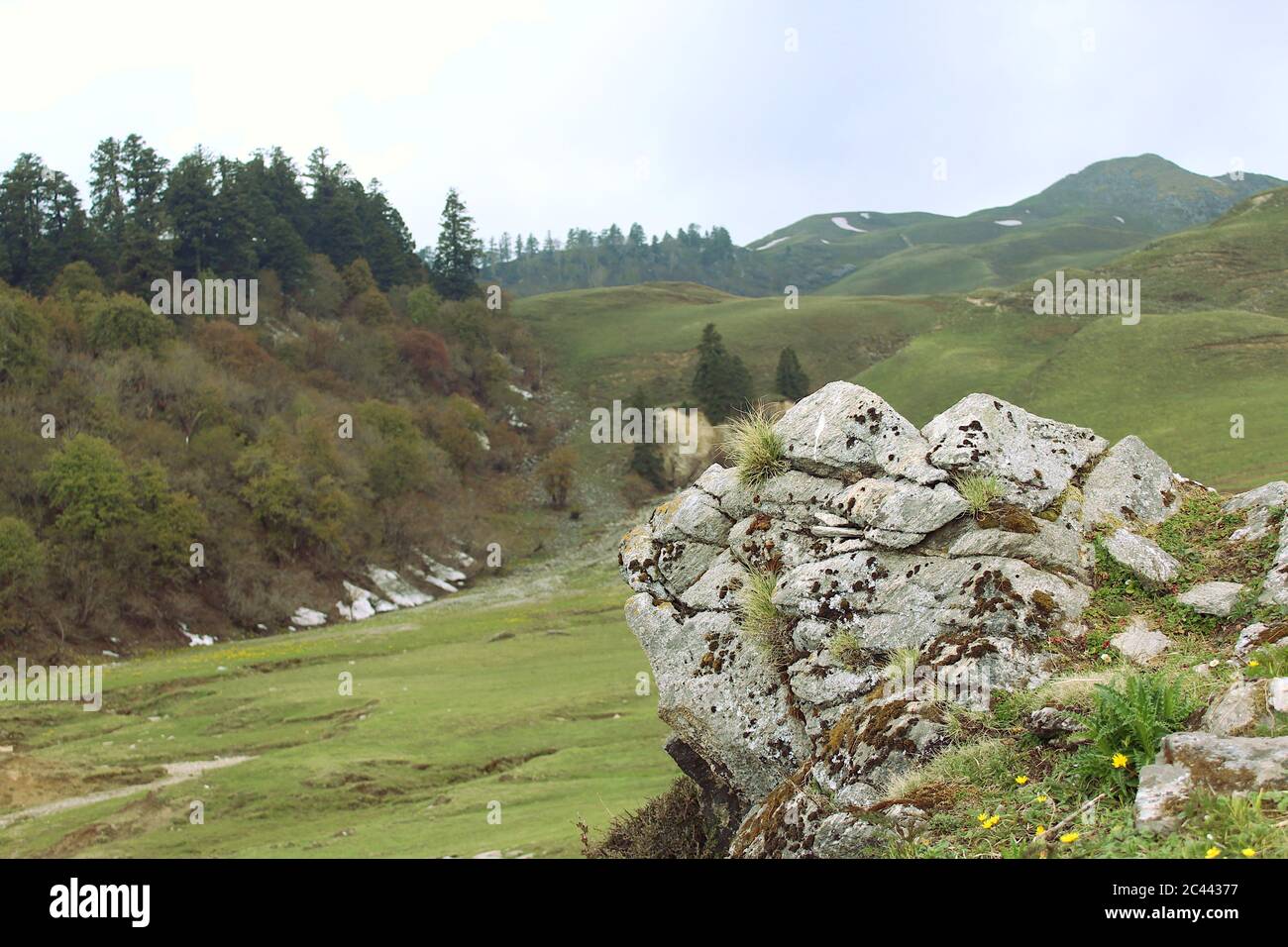 big stone in the valley with a blurred landscape view behind Stock ...