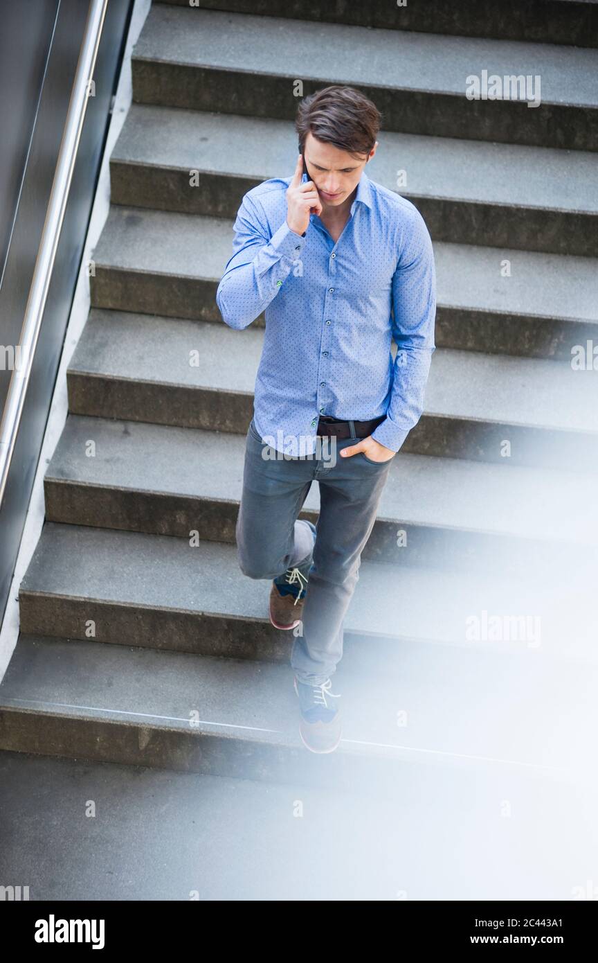 Smart man walking down steps hi-res stock photography and images - Alamy