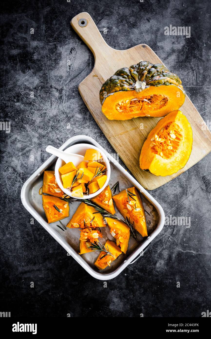 Overhead view of slices and chopped pumpkin in baking tray Stock Photo ...