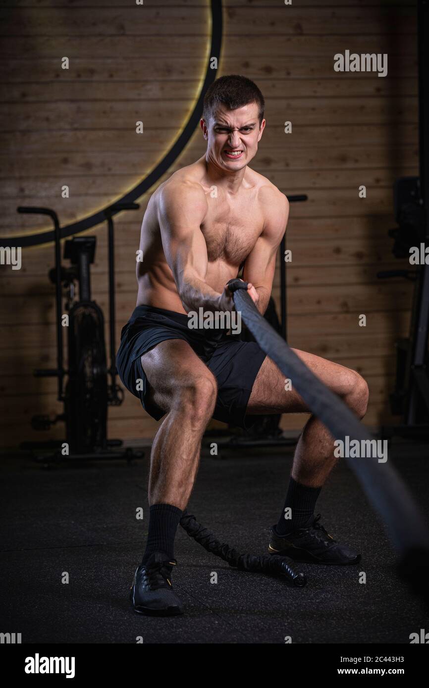 CrossFit athlete pulling rope Stock Photo - Alamy