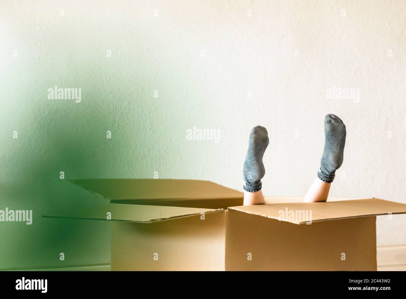 Feet of girl inside a cardboard box Stock Photo - Alamy