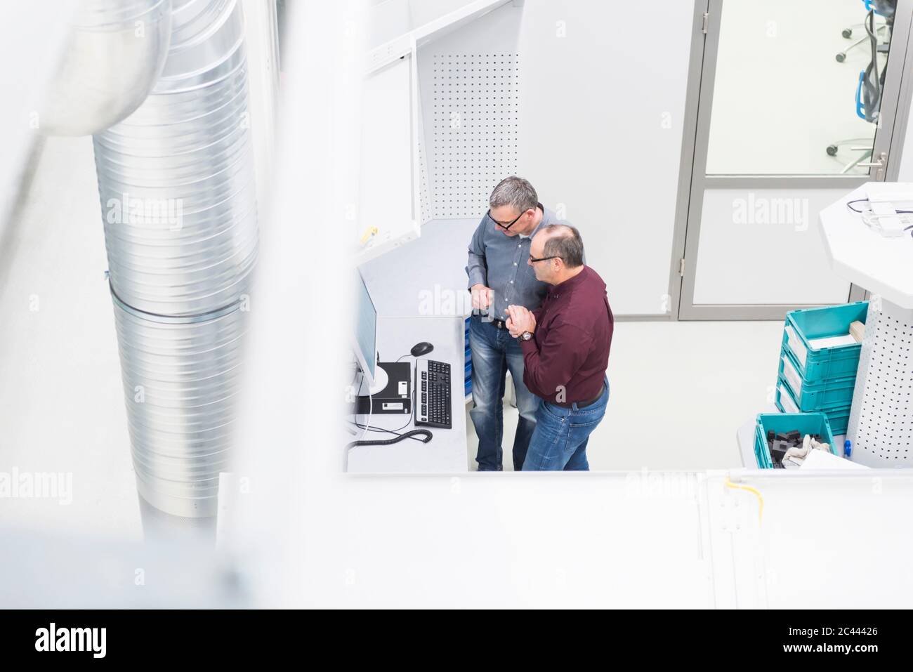Two businessmen having a discussion in a factory Stock Photo - Alamy