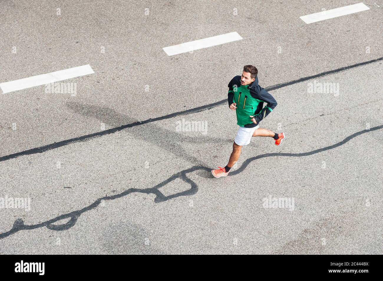 Bird's eye view of young man running on a road Stock Photo - Alamy