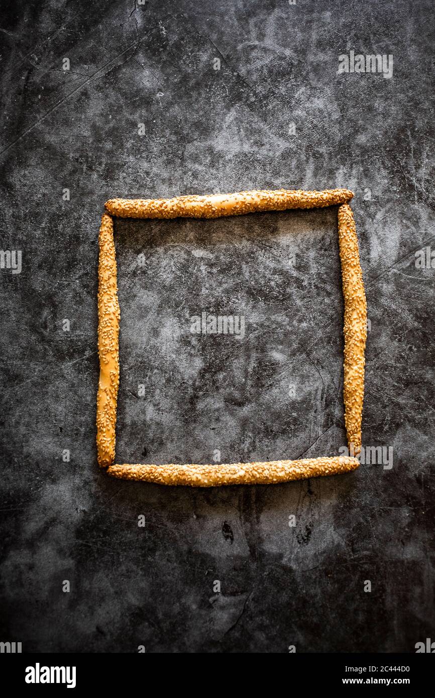 Studio shot of Italian grissini breadsticks arranged into square shape ...