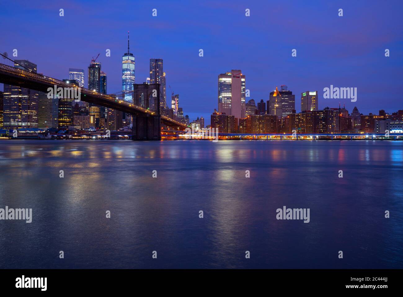 USA, New York, New York City, East River and Brooklyn Bridge at purple ...