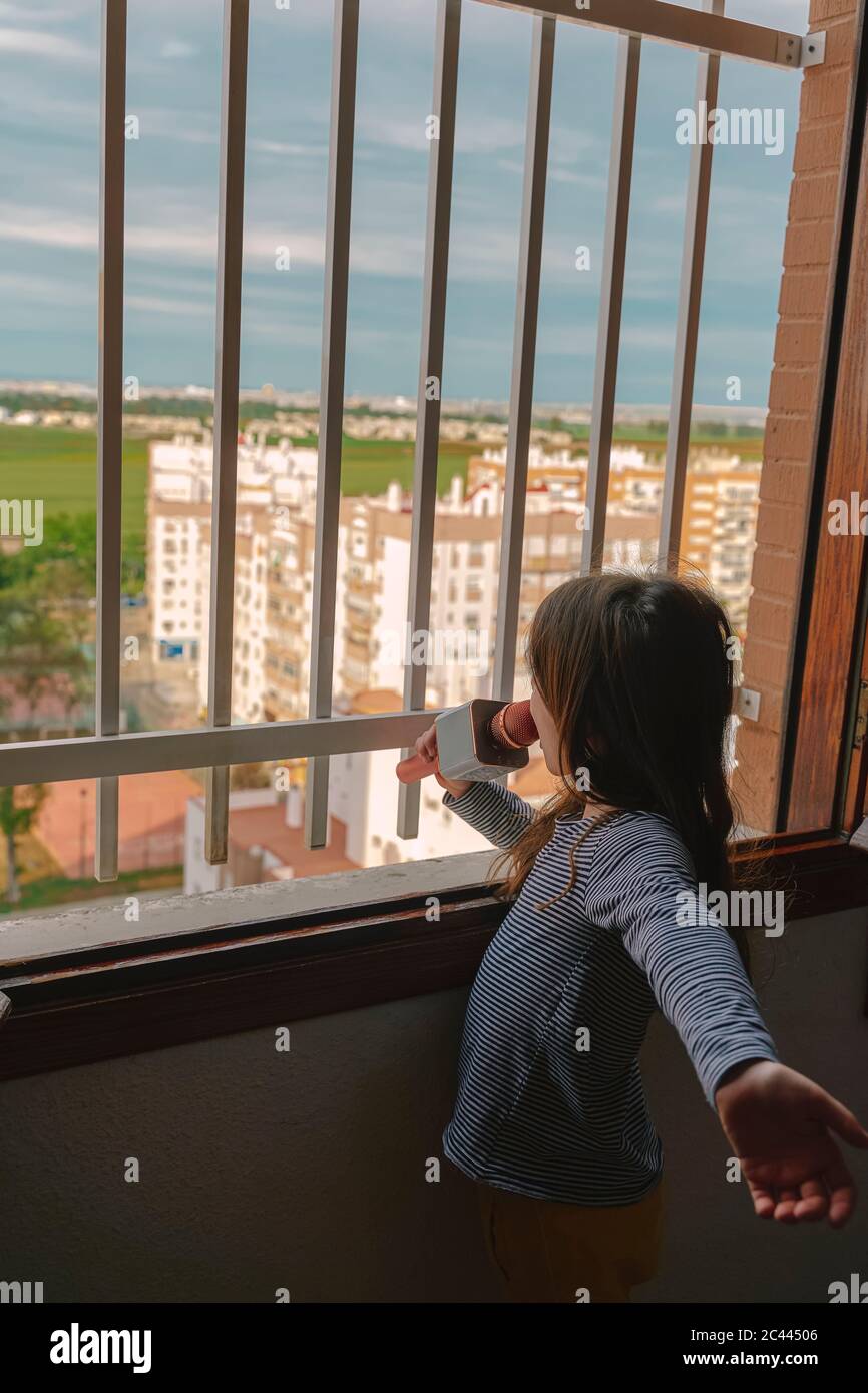 Girl singing at open window Stock Photo - Alamy
