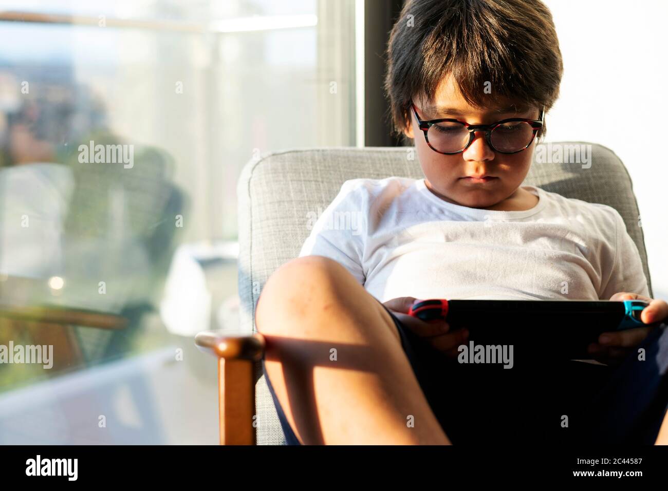 Boy playing video game on a games console Stock Photo - Alamy