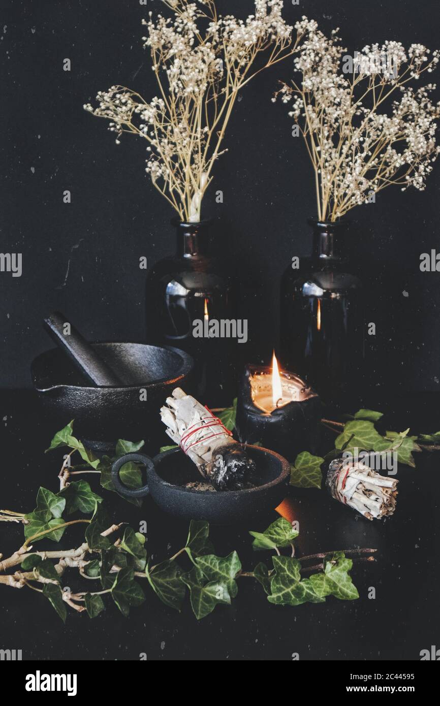 Vertical photo of sage sticks on wiccan witch altar. Two smudge sticks ...