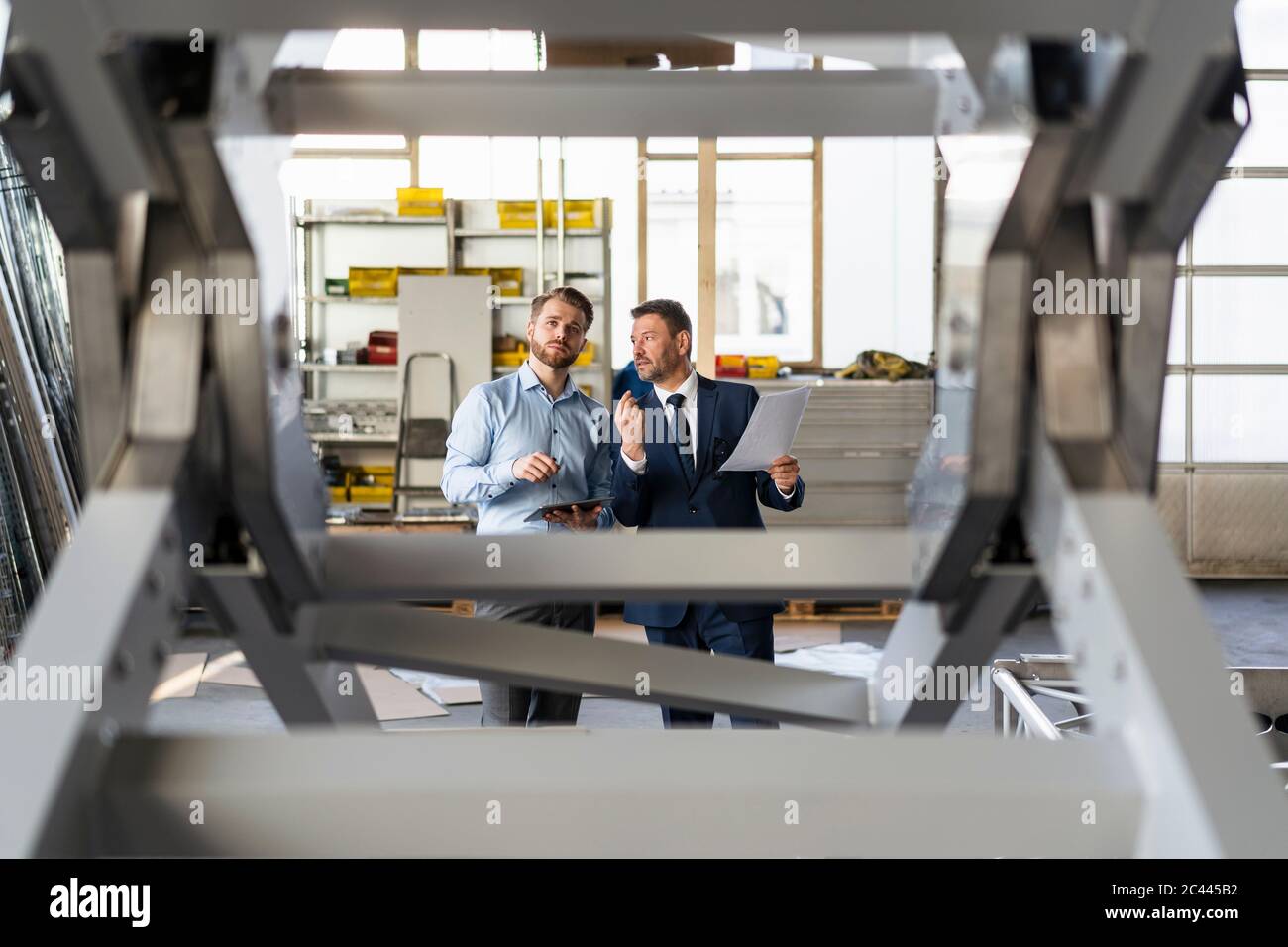 Two businessmen having a meeting in a factory Stock Photo - Alamy