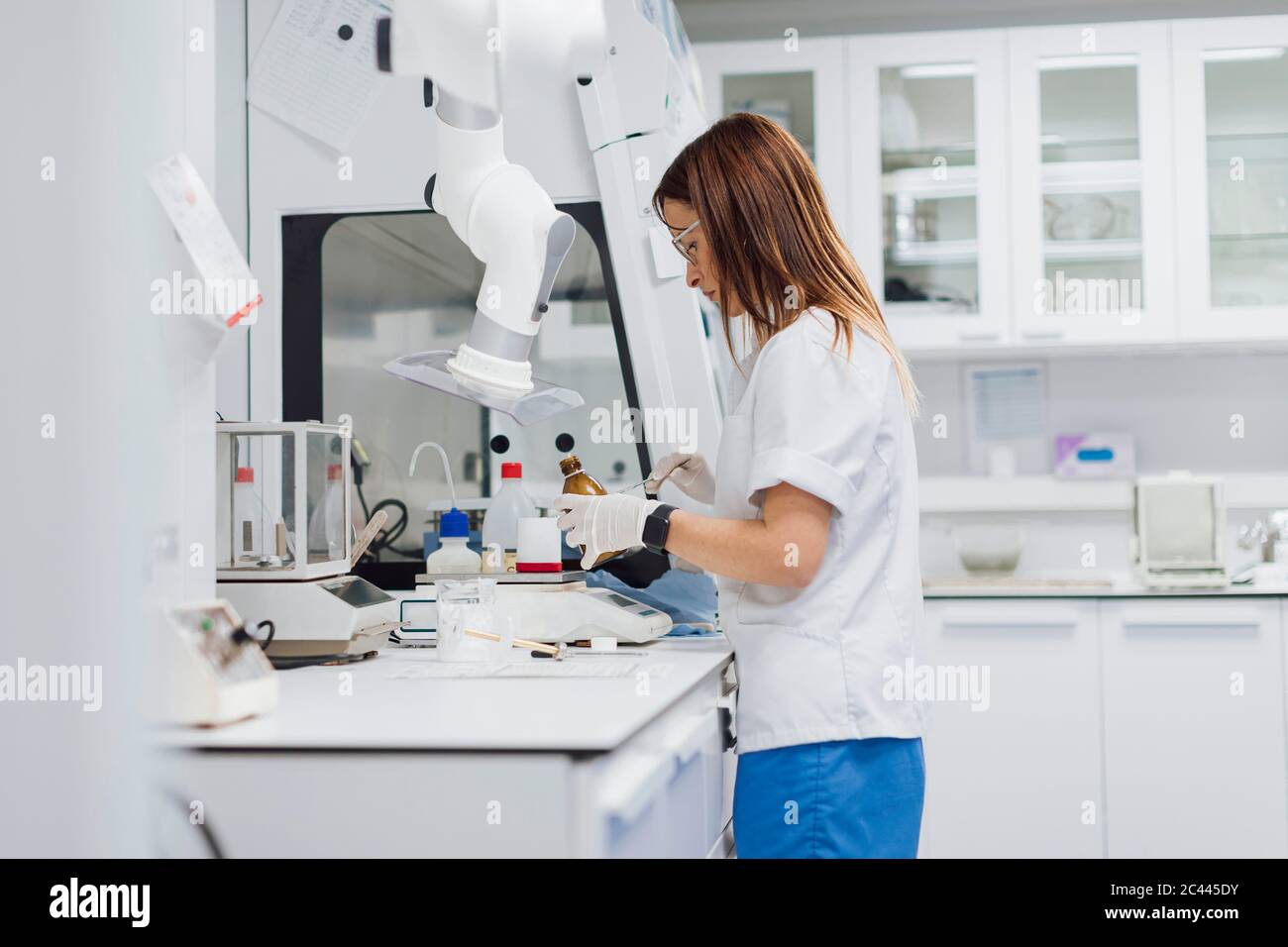 Female scientist with long brown hair working at laboratory Stock Photo ...