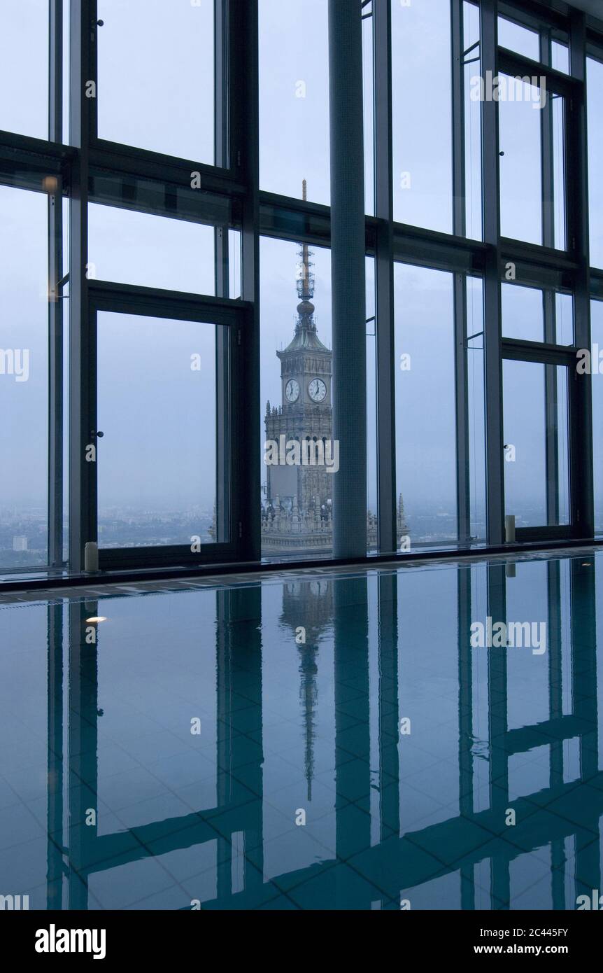 Tower clock behind the glass facade of an indoor pool Stock Photo - Alamy