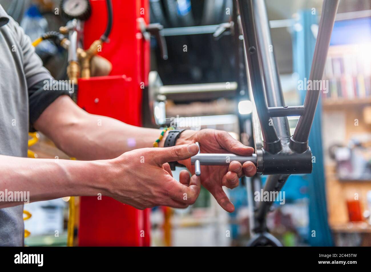 Bicycle mechanic working at inner bearing of bike Stock Photo - Alamy