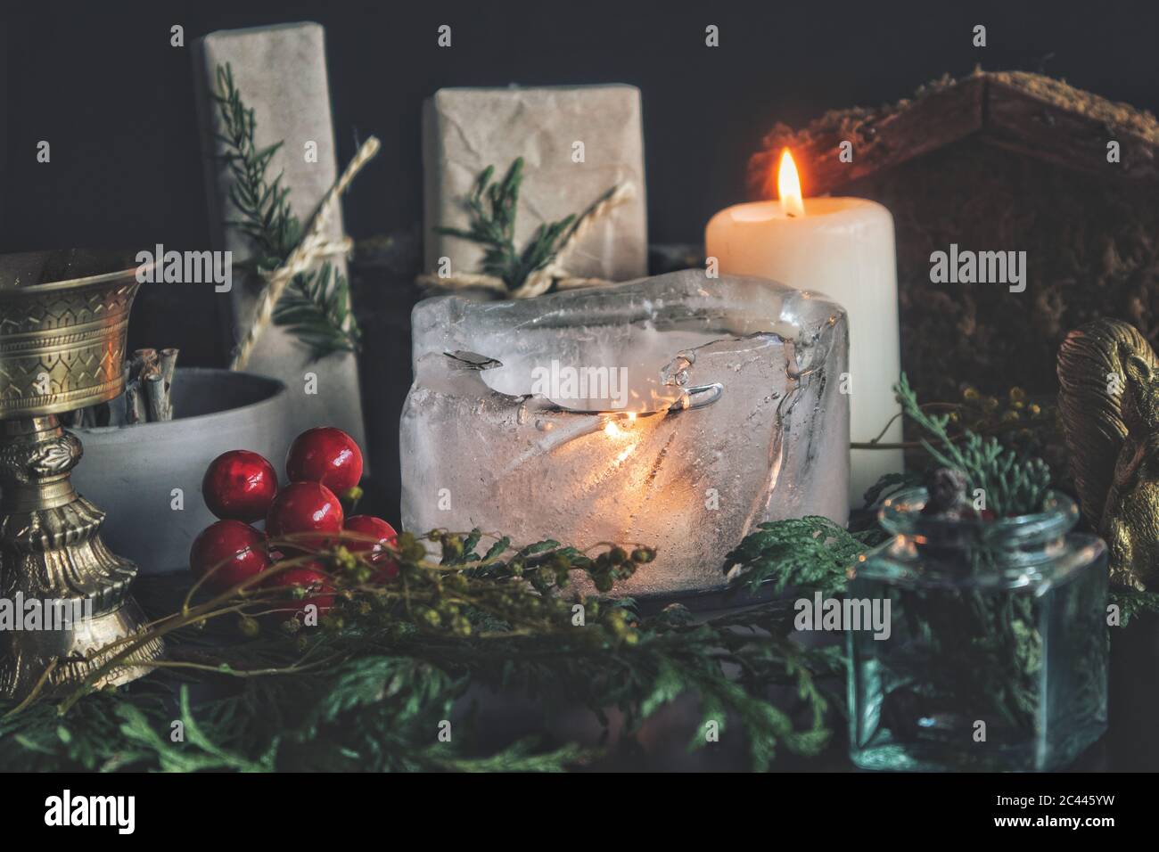 Close up of candle burning in ice. Festive Yule winter solstice ...