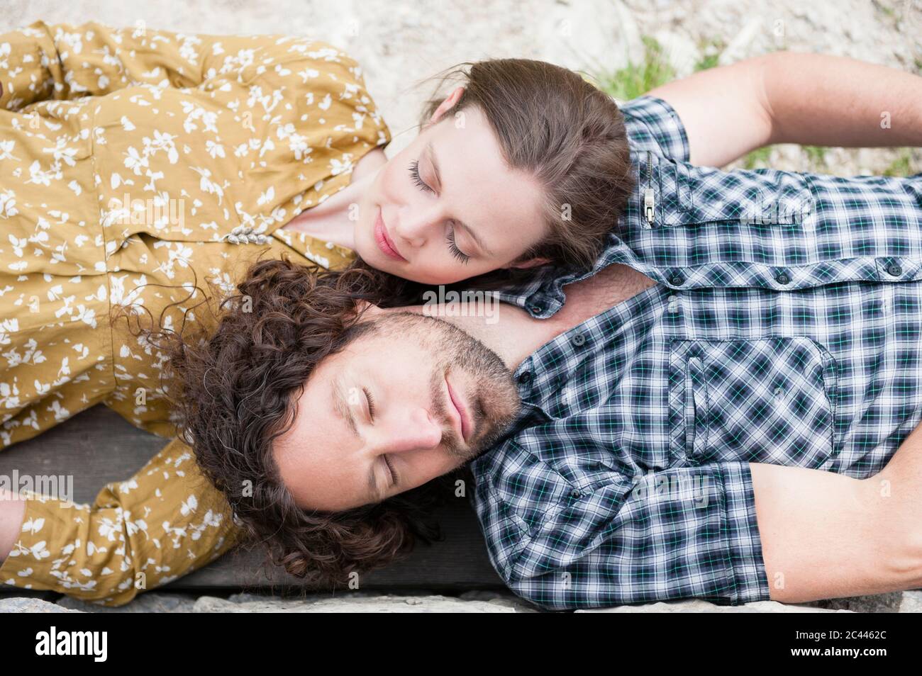 Mid adult couple relaxing while lying outdoors Stock Photo - Alamy
