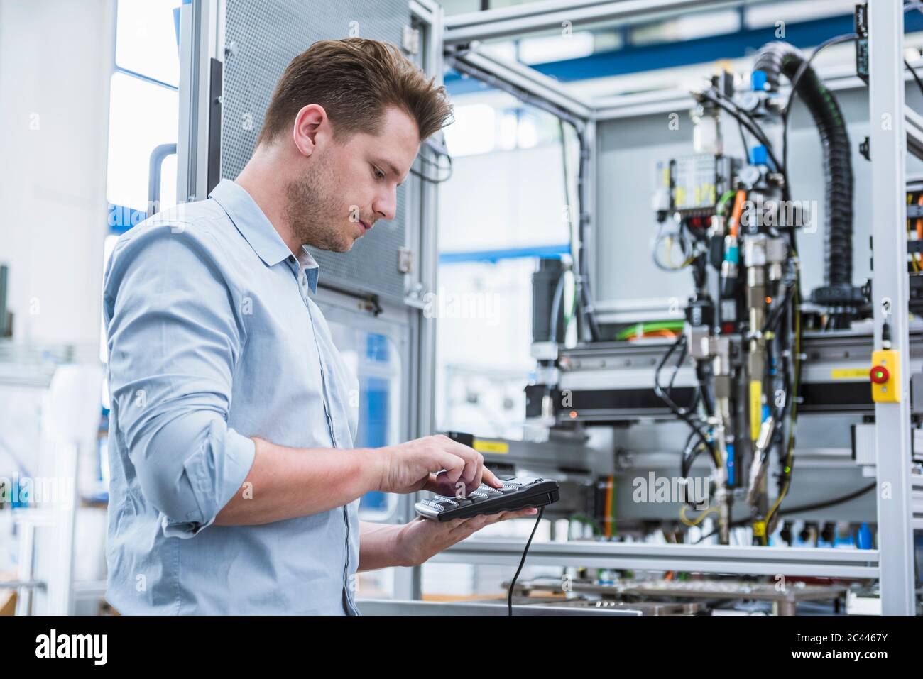 Man using keyboard in factory Stock Photo - Alamy
