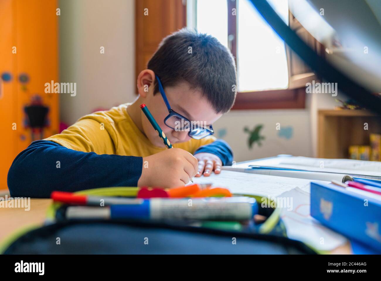 Boy writing book hi-res stock photography and images - Alamy