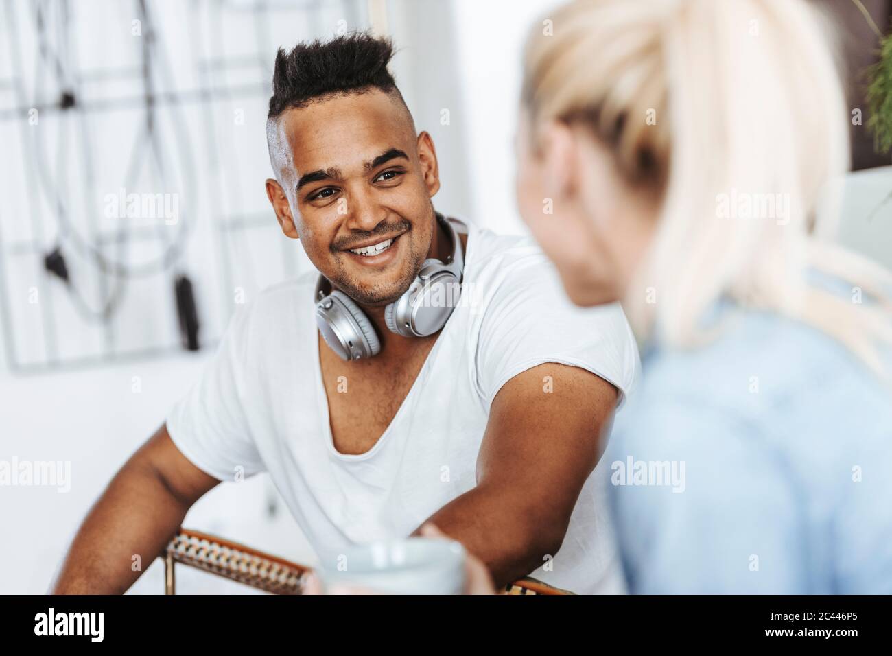 Two friends talking listening indoors hi-res stock photography and ...